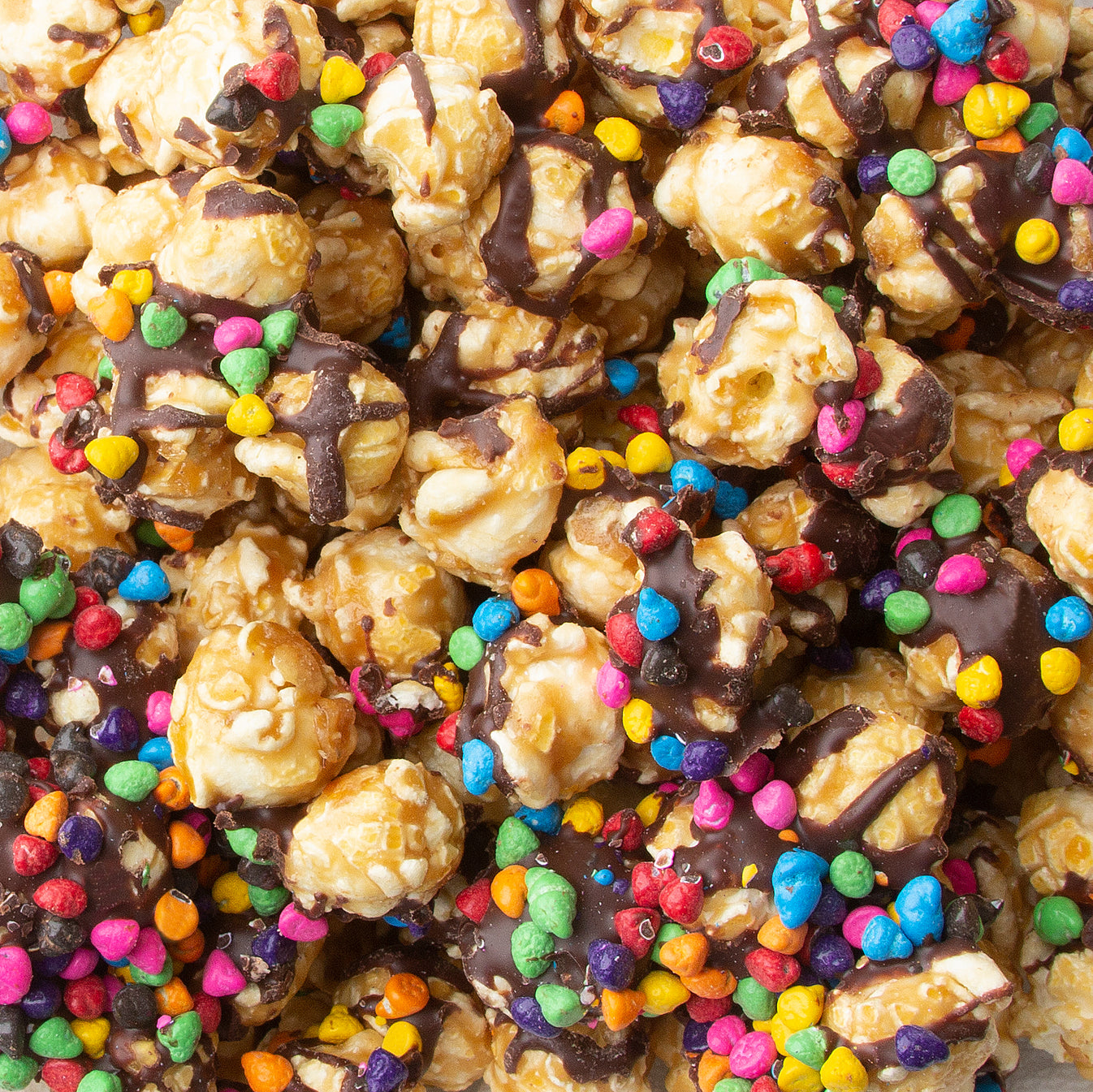 Chocolate Drizzled Caramel Popcorn with Rainbow Chips - 16oz Tub – Oh! Nuts